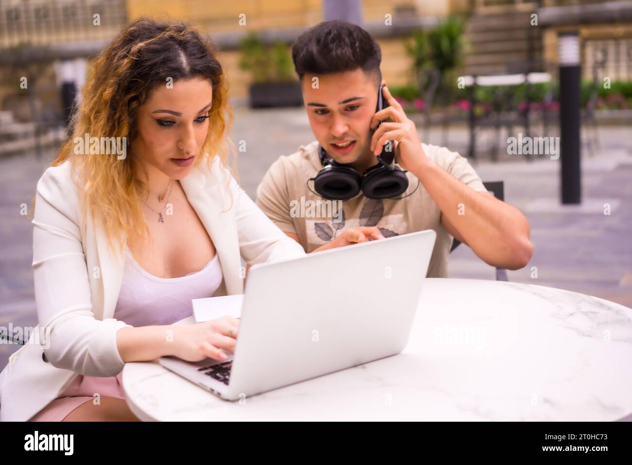 Young entrepreneurs doing teamwork. Working with the computer on a ...