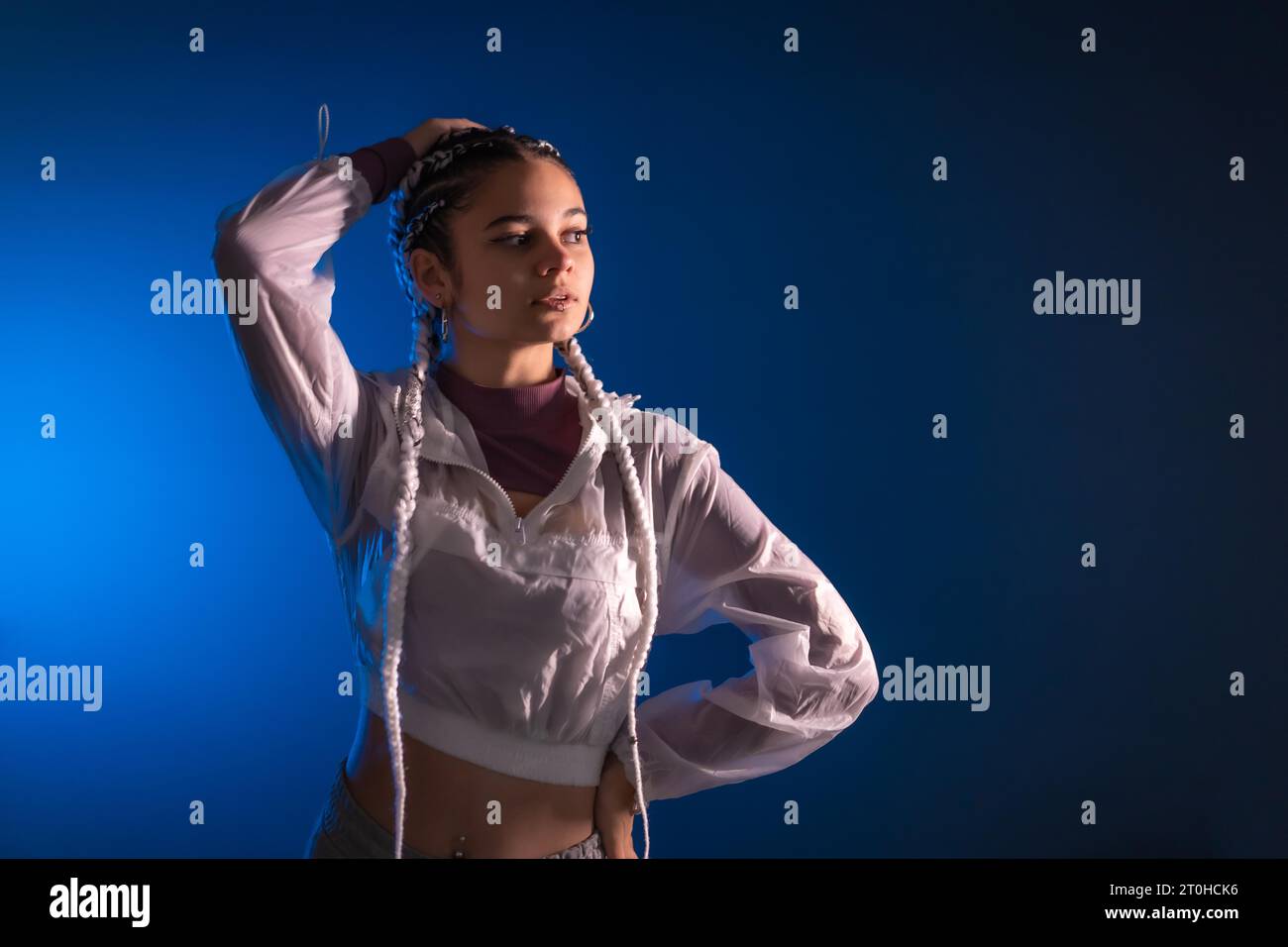 Urban session. Young caucasian woman with long white braids on a blue ...