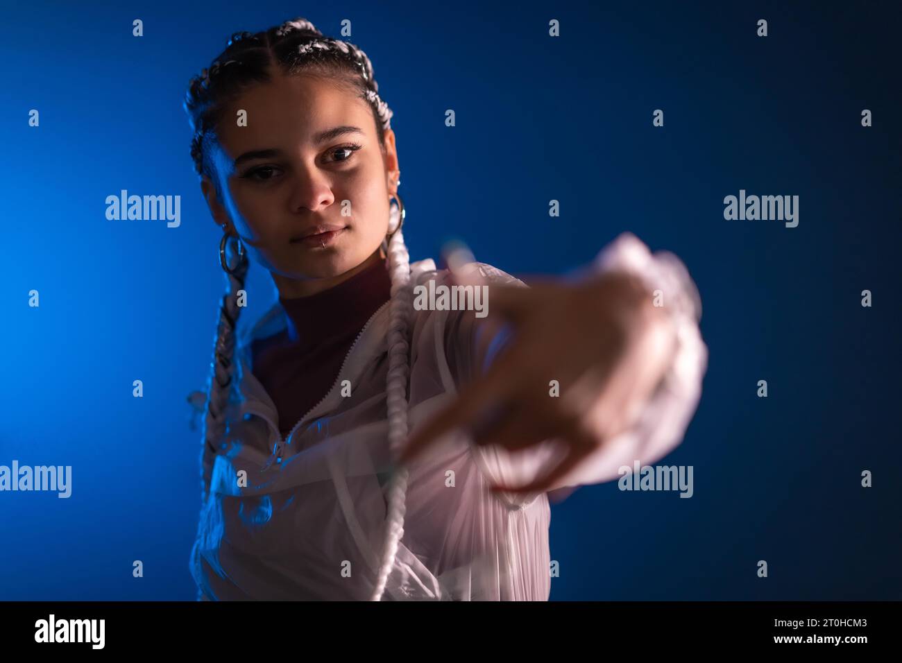 Urban session. Young caucasian woman with long white braids on a blue ...