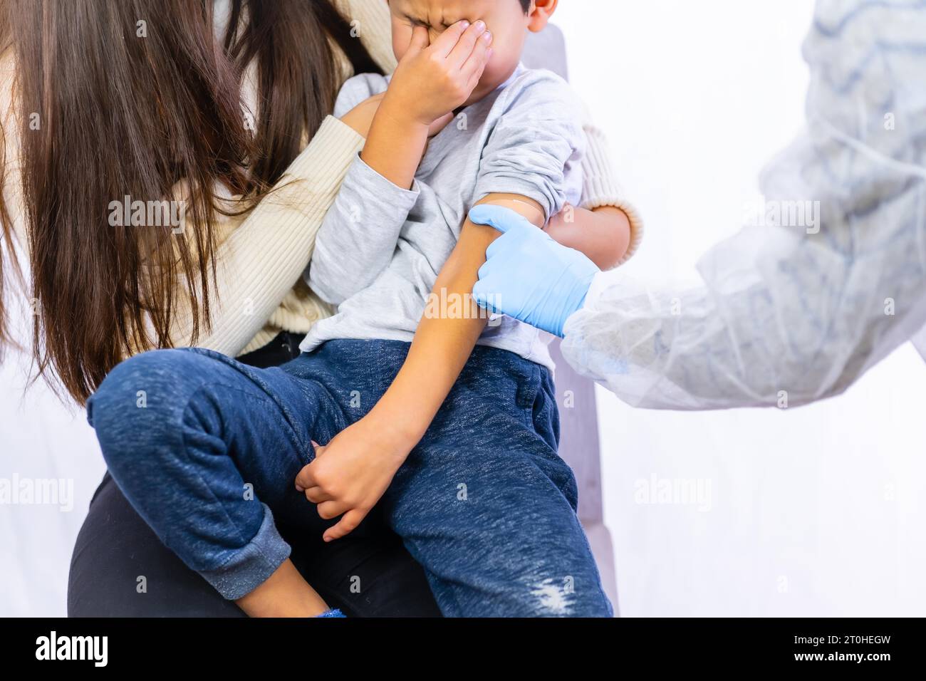 Crying child after vaccination injection by a female doctor ...
