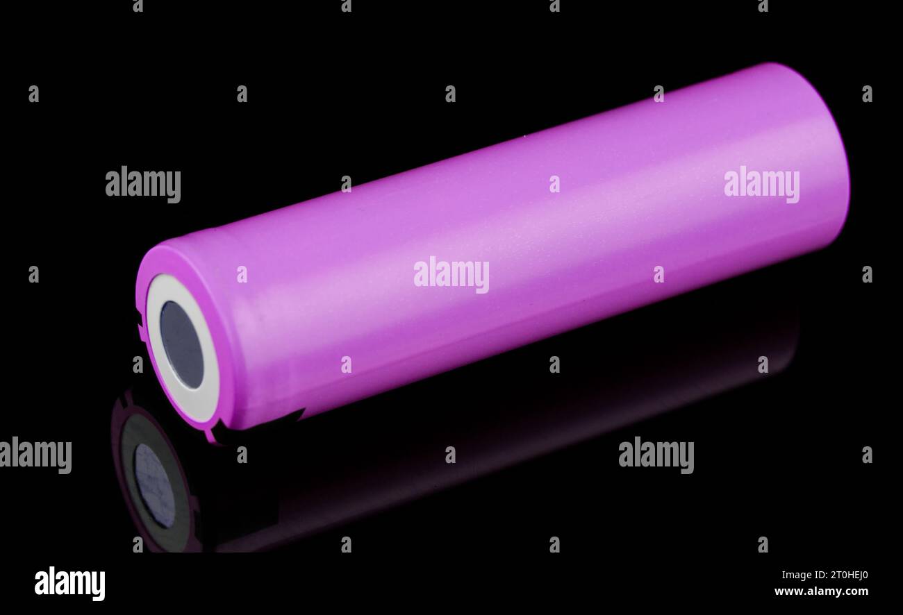 Battery 18650 purple on a black background close-up Stock Photo - Alamy