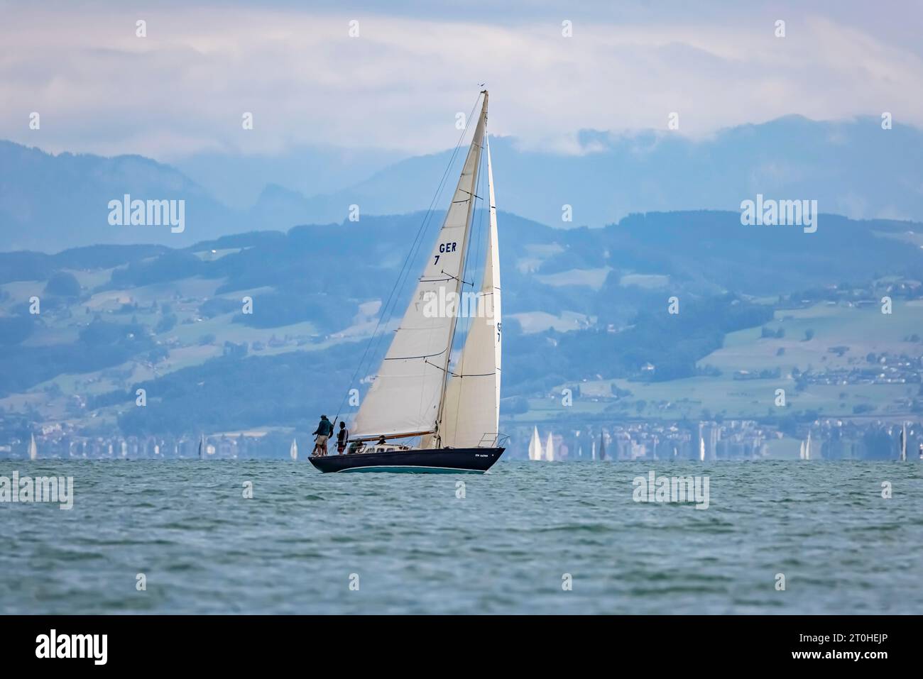 Sailing boat on Lake Constance, on the horizon the Swiss shore and ...