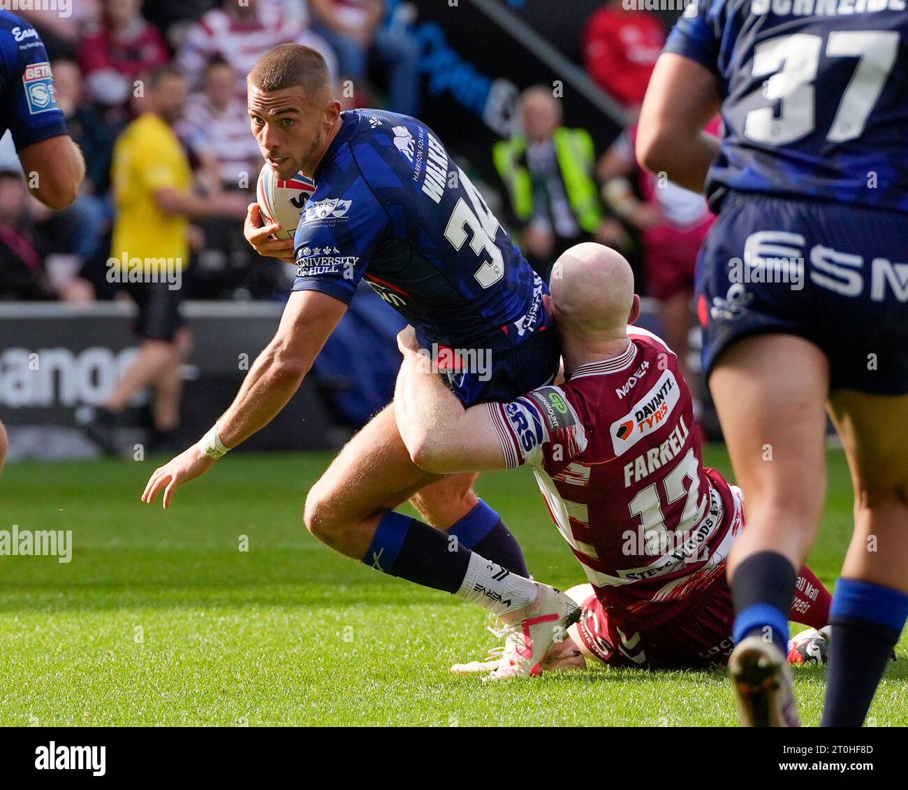Morgan Smithies #13 of Wigan Warriors tackles Jack Walker #34 of Hull ...