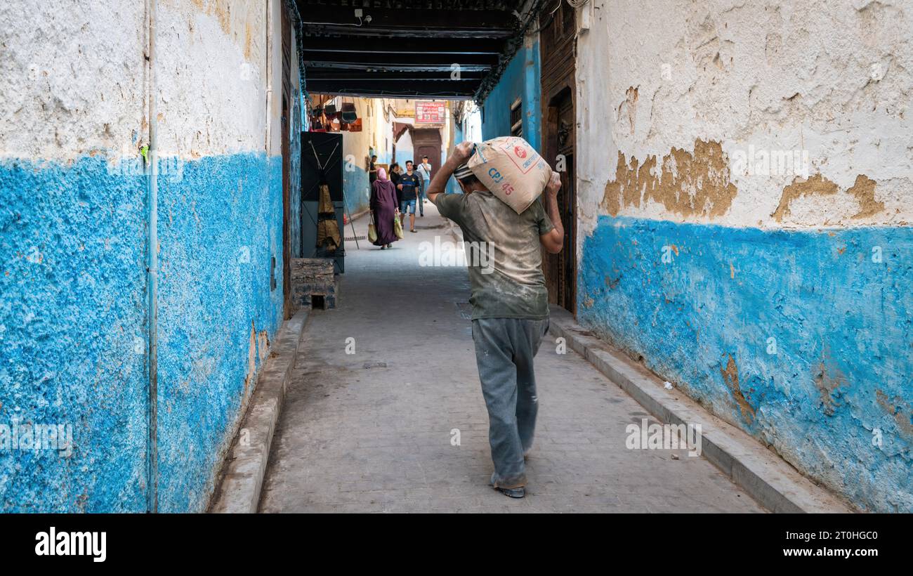 Fes, Morocco - 10 September 2022: Moroccan man carrying goods in a ...