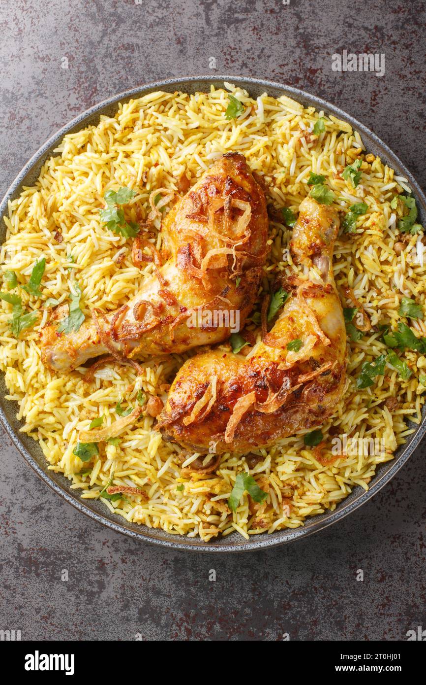 Bangladeshi spicy roast chicken served with aromatic pilaf close-up in ...