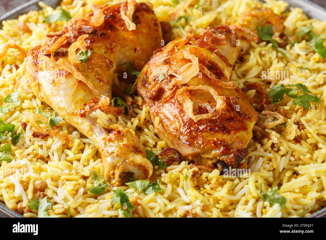 Asian food Roast Chicken legs with fried onion and garnish with polao ...