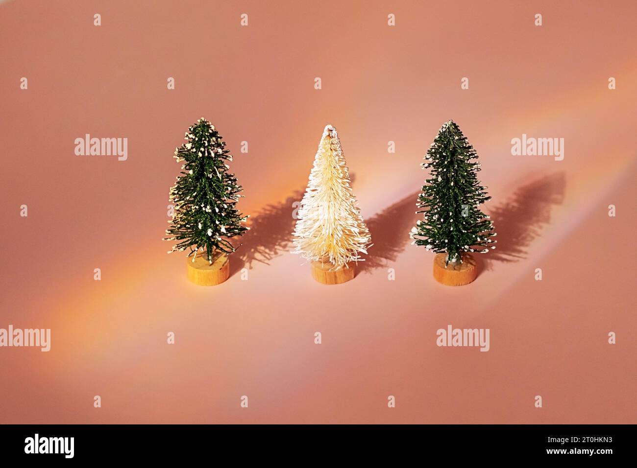 Artificial Christmas trees in rainbow flare leak. Winter holidays ...