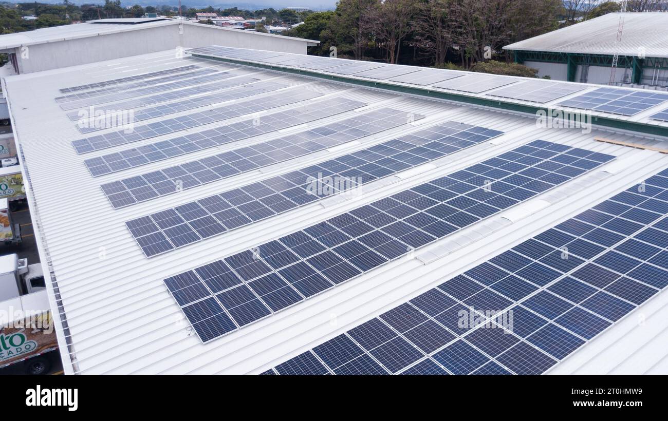 View of the installation of solar panels on a warehouse roof -green ...