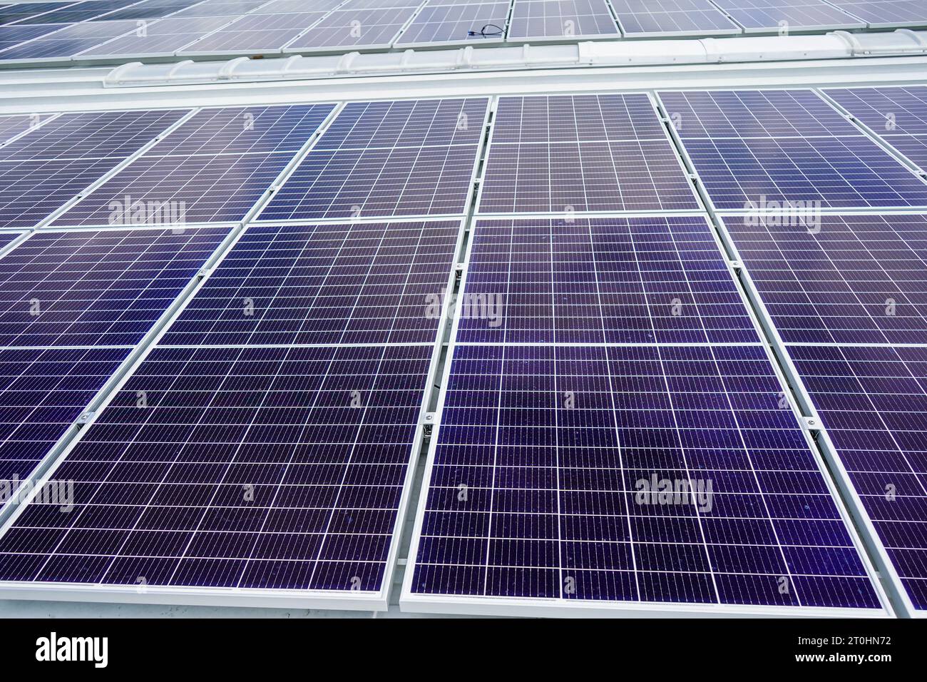 View of the installation of solar panels on a warehouse roof -green ...