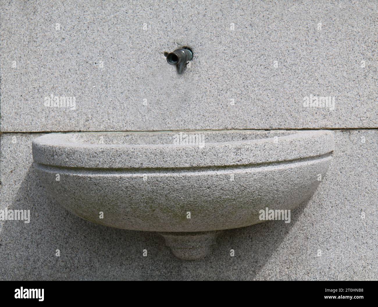 An Outdoor Drinking Water Tap Over a Stone Bowl Stock Photo - Alamy