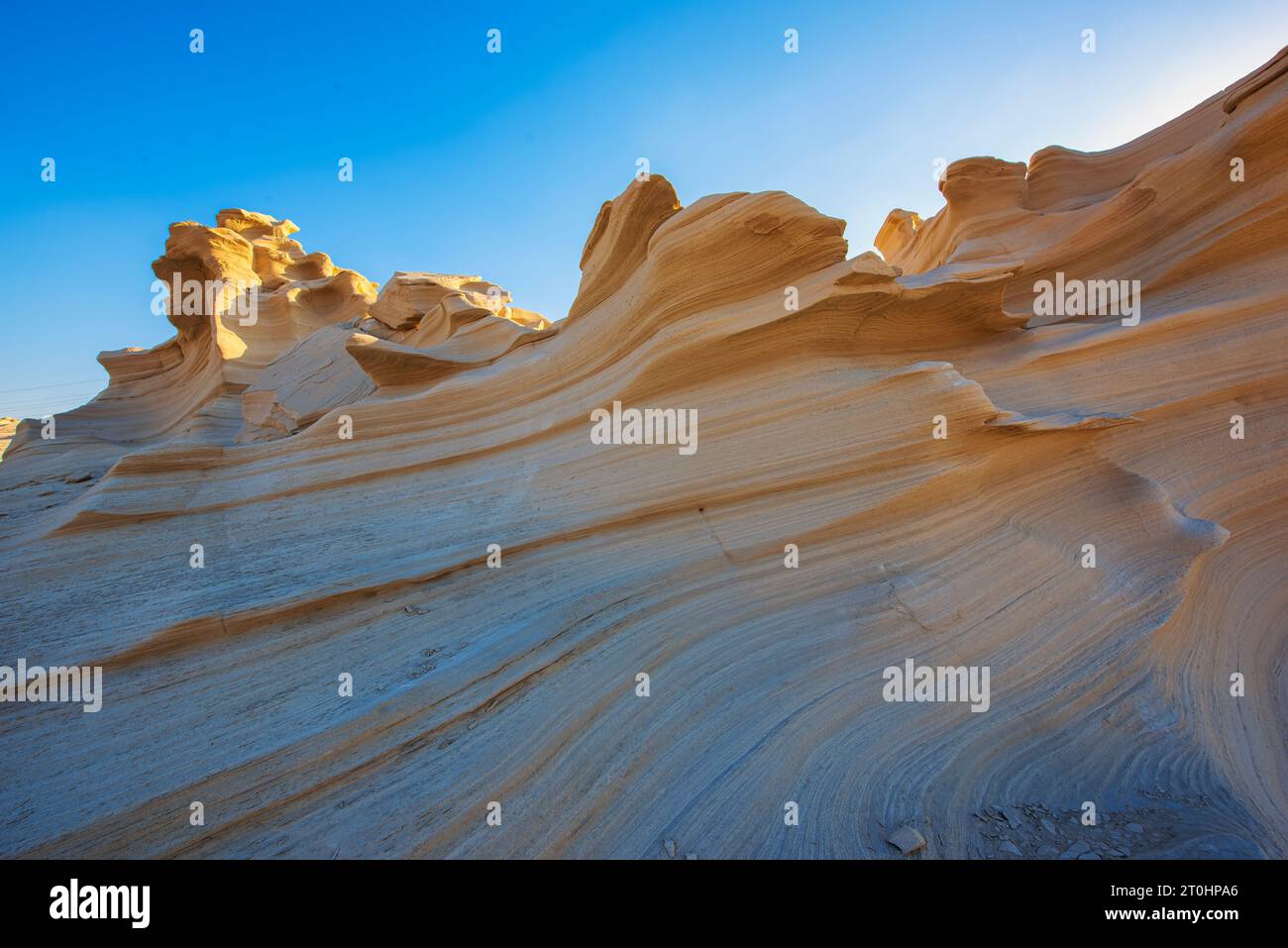 Desert eroded rock pattern with clear sky. Desert rock formation with ...