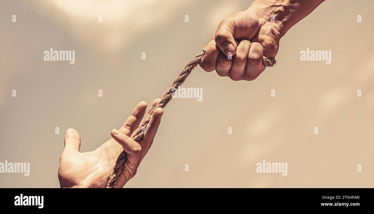 Rescue, help, helping gesture or hands. Conflict tug of war. Rope, cord. Hand holding a rope ...