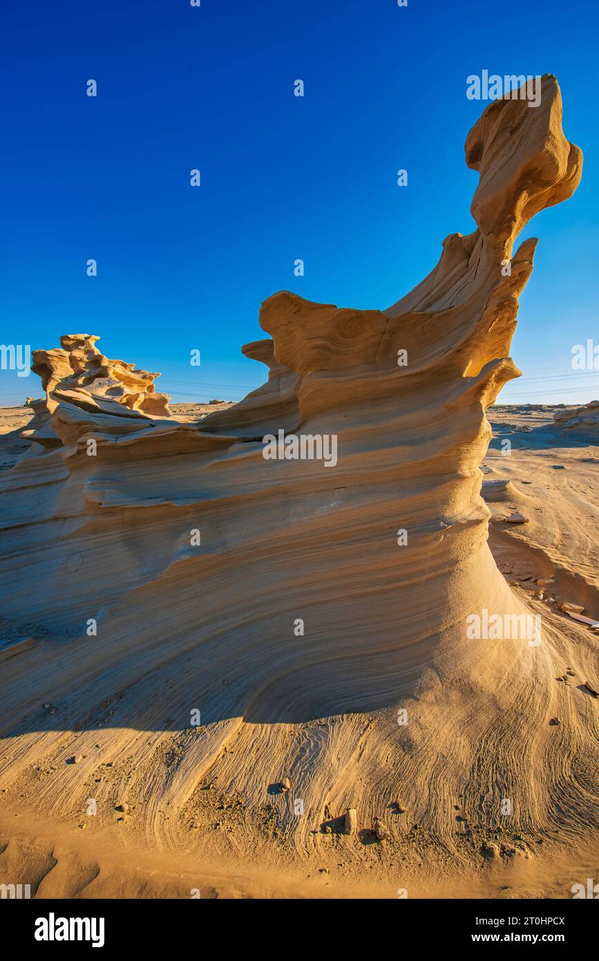 Desert eroded rock pattern with clear sky. Desert rock formation with ...