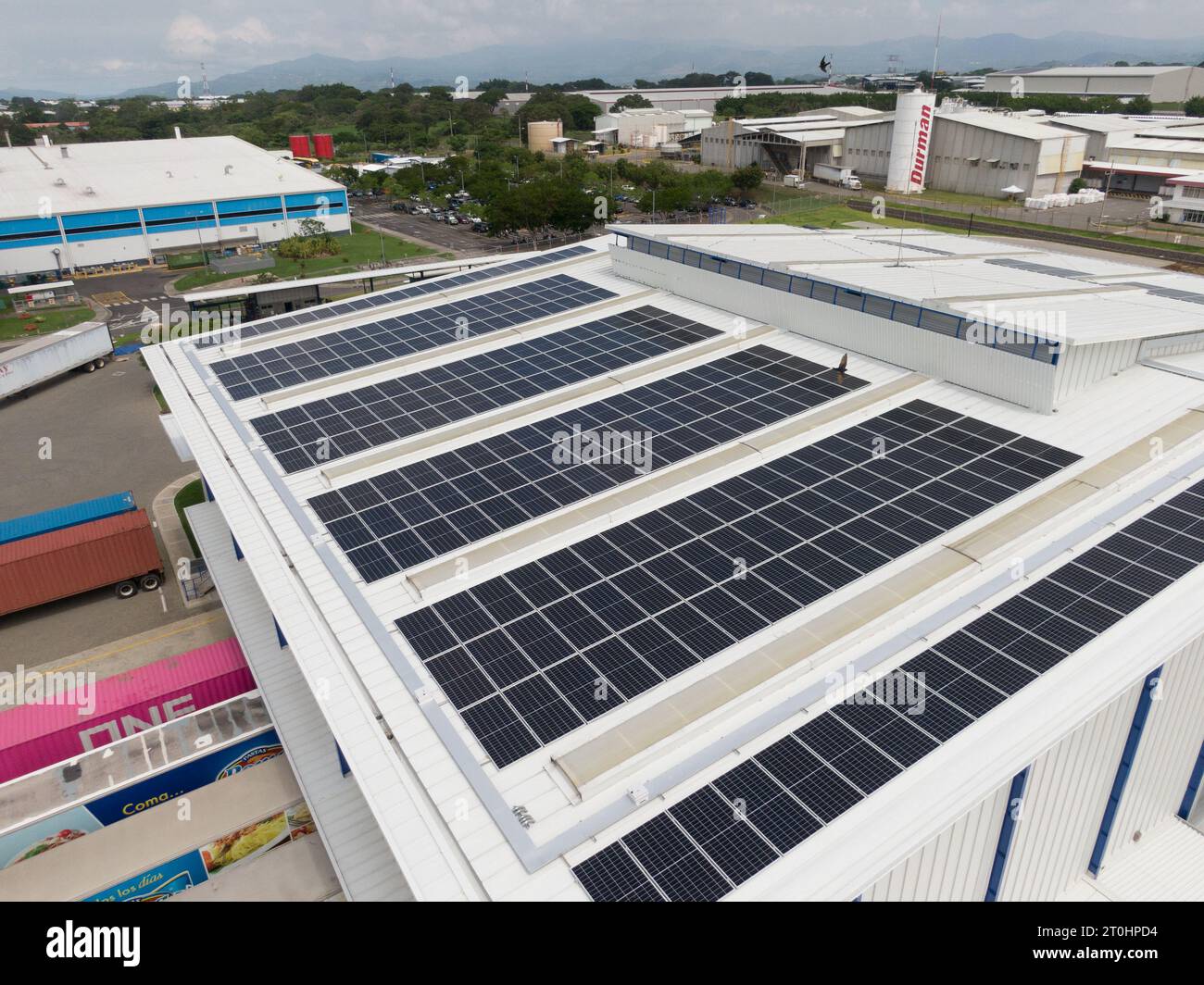 View of the installation of solar panels on a warehouse roof -green energy - renewable energy ...