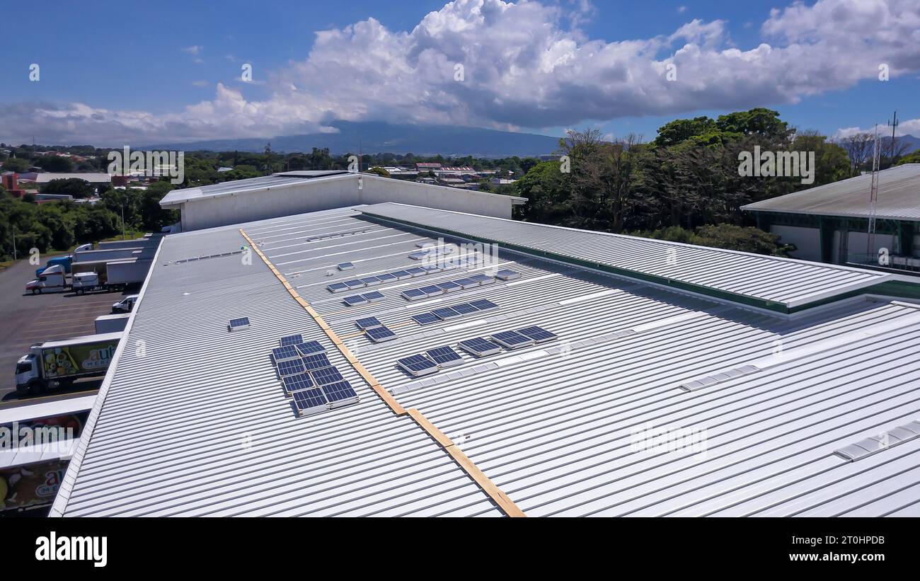 View of the installation of solar panels on a warehouse roof -green ...