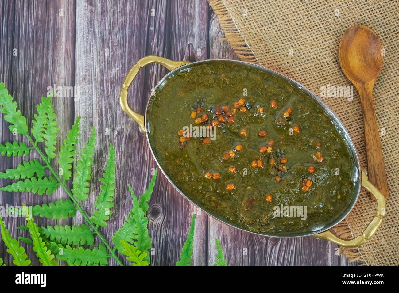 Traditionally cooked spinach is mashed with a wooden mathu , whisk ...