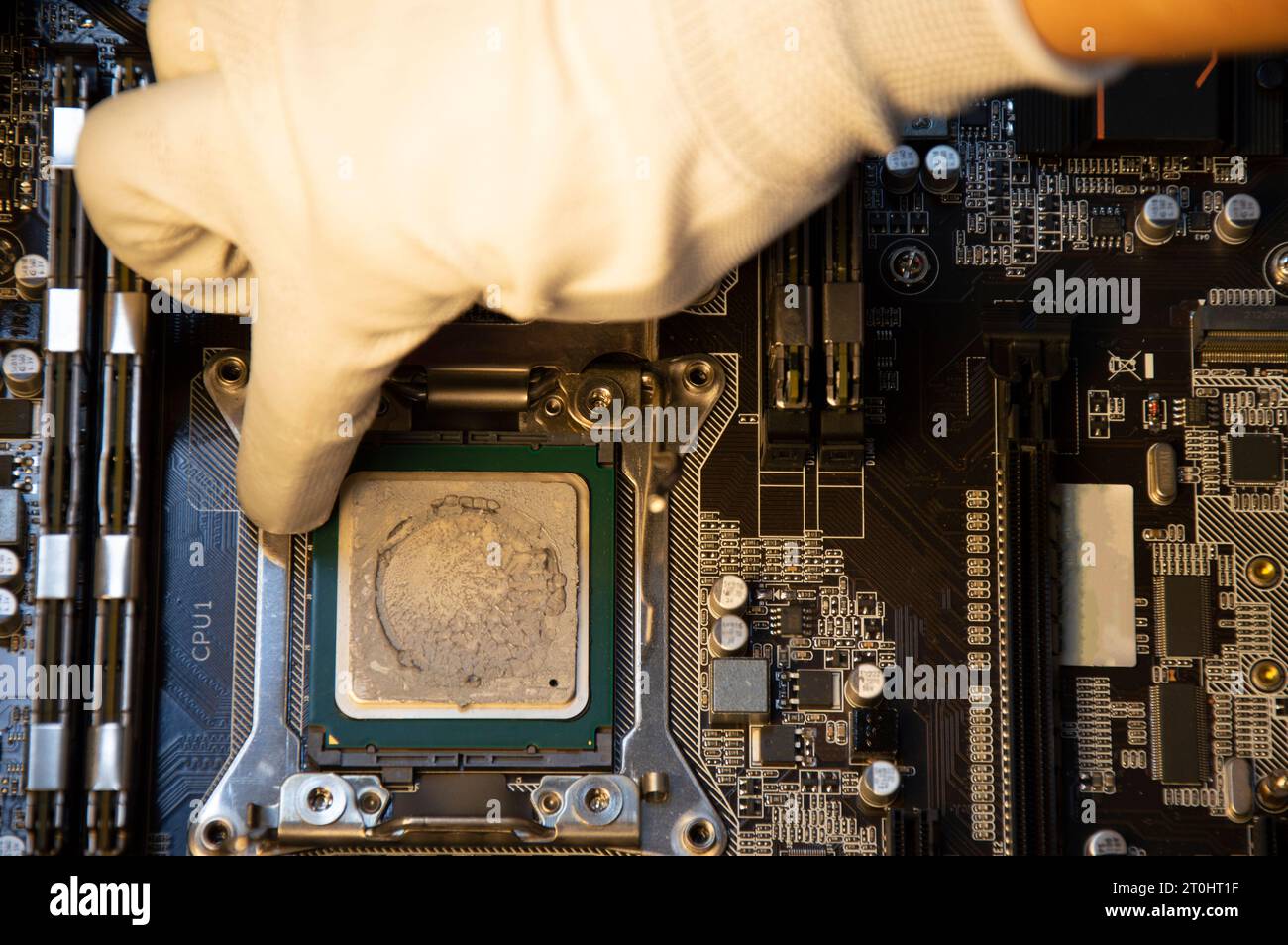 Top view of technician installing CPU chip onto motherboard Stock Photo - Alamy