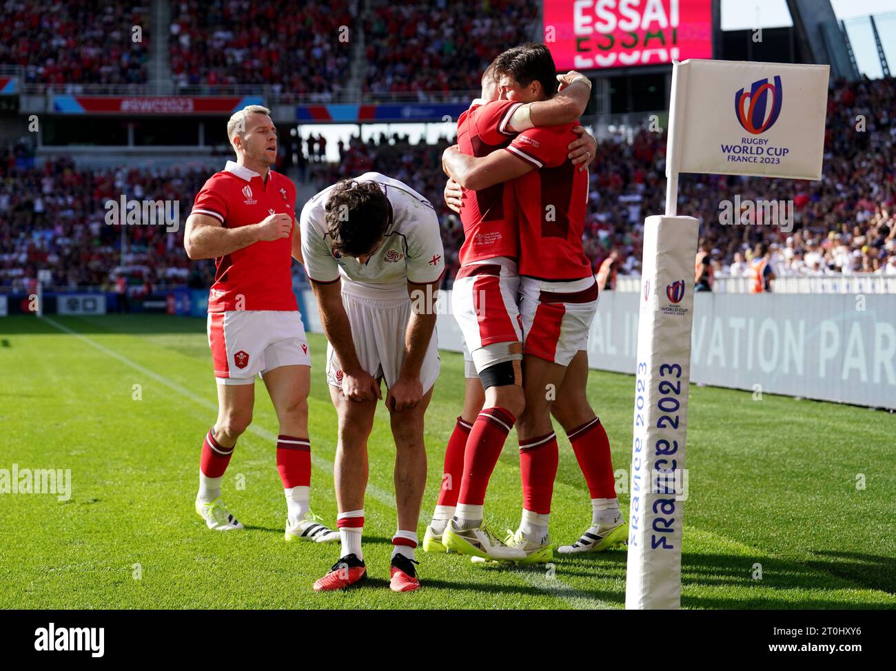 Wales' Louis Rees-Zammit (right) is congratulated by his team mates ...