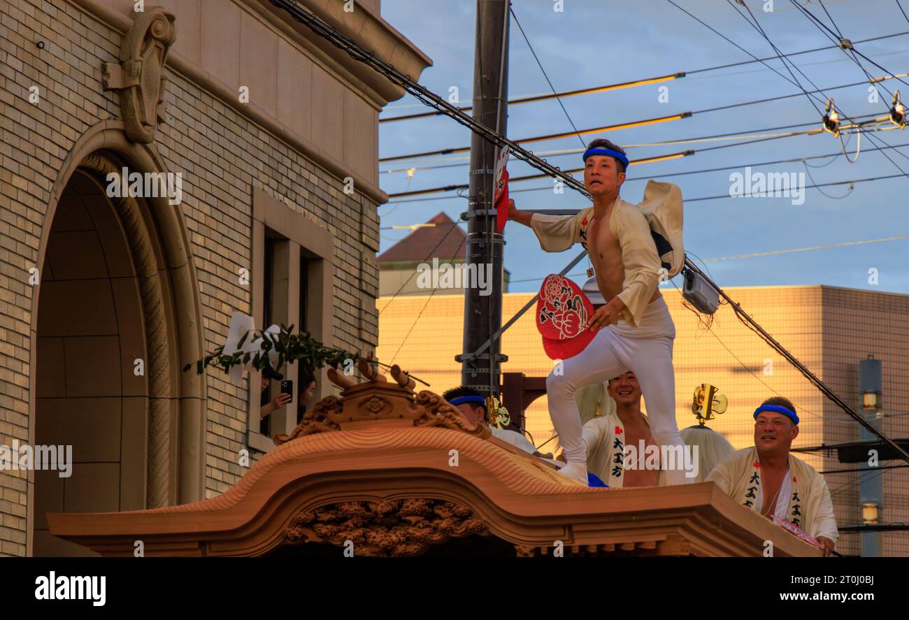 Kishiwada, Japan - September 17, 2023: Dancer with fans atop mikoshi ...