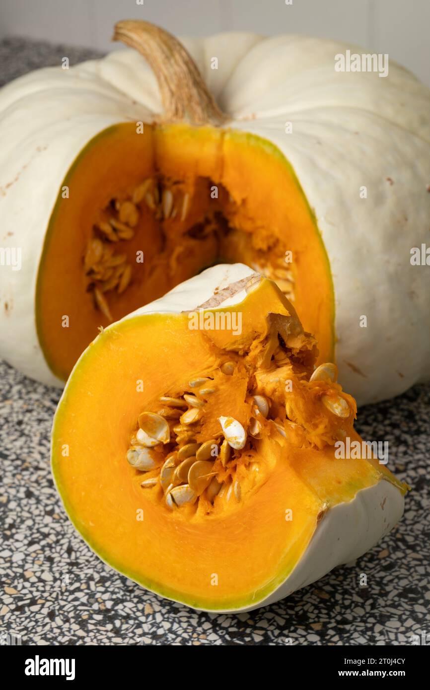 Fresh Flat White Boer Pumpkin and a wedge close up Stock Photo - Alamy
