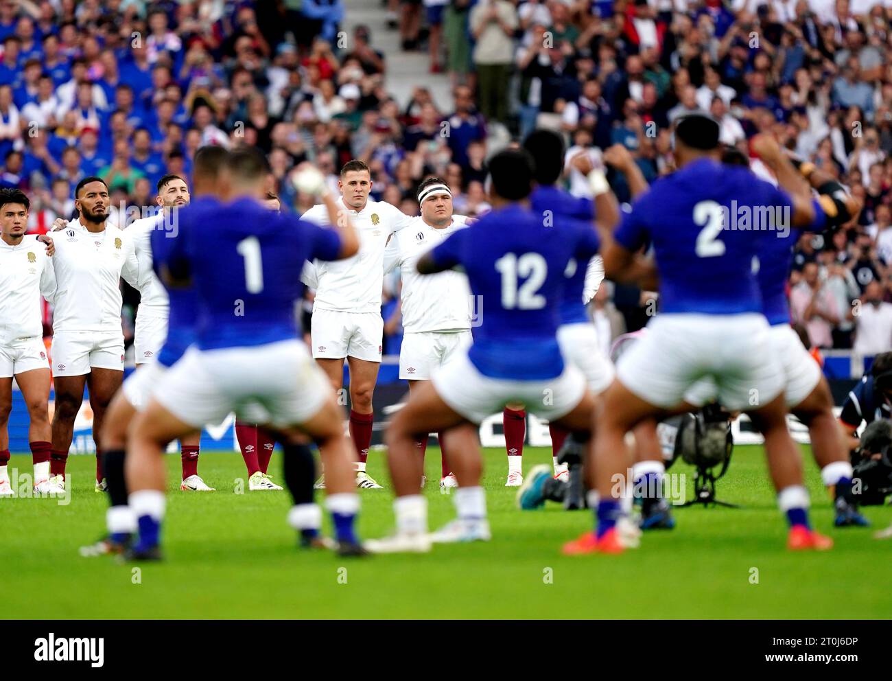 England players look on as Samoa perform a haka ahead of the Rugby ...