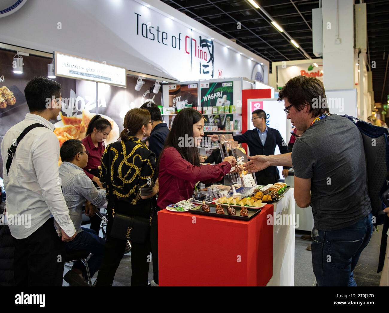 Cologne, Germany. 7th Oct, 2023. People visit the booth of a Chinese company at the food and ...