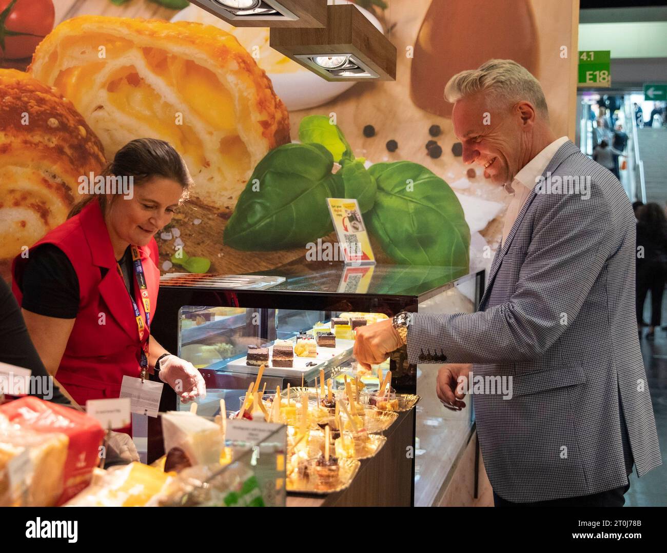 Cologne, Germany. 7th Oct, 2023. A visitor tastes desserts at the food ...