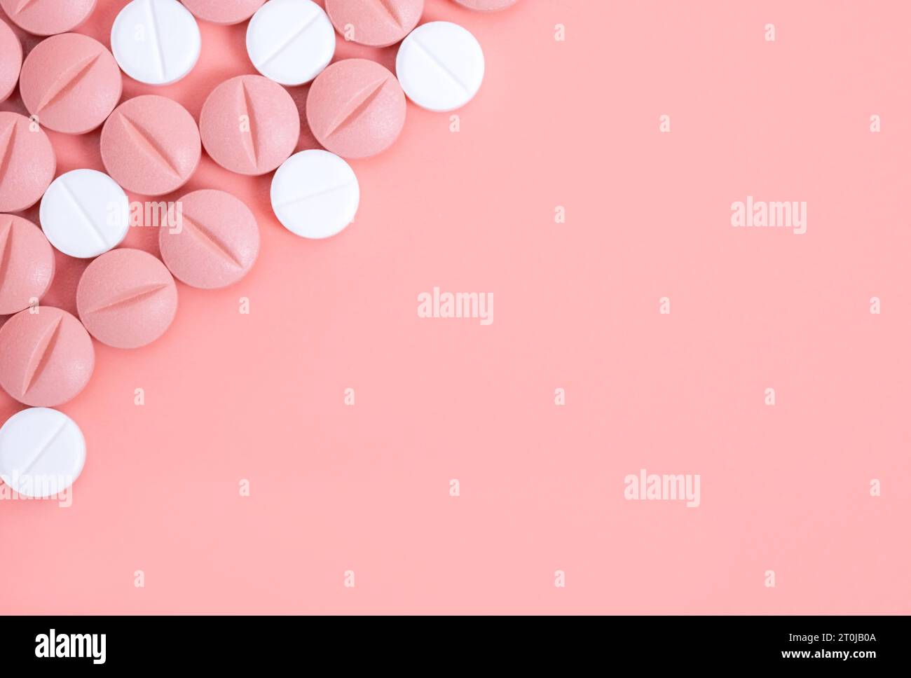 Pink background with pink and white pills in left upper corner. Medical ...