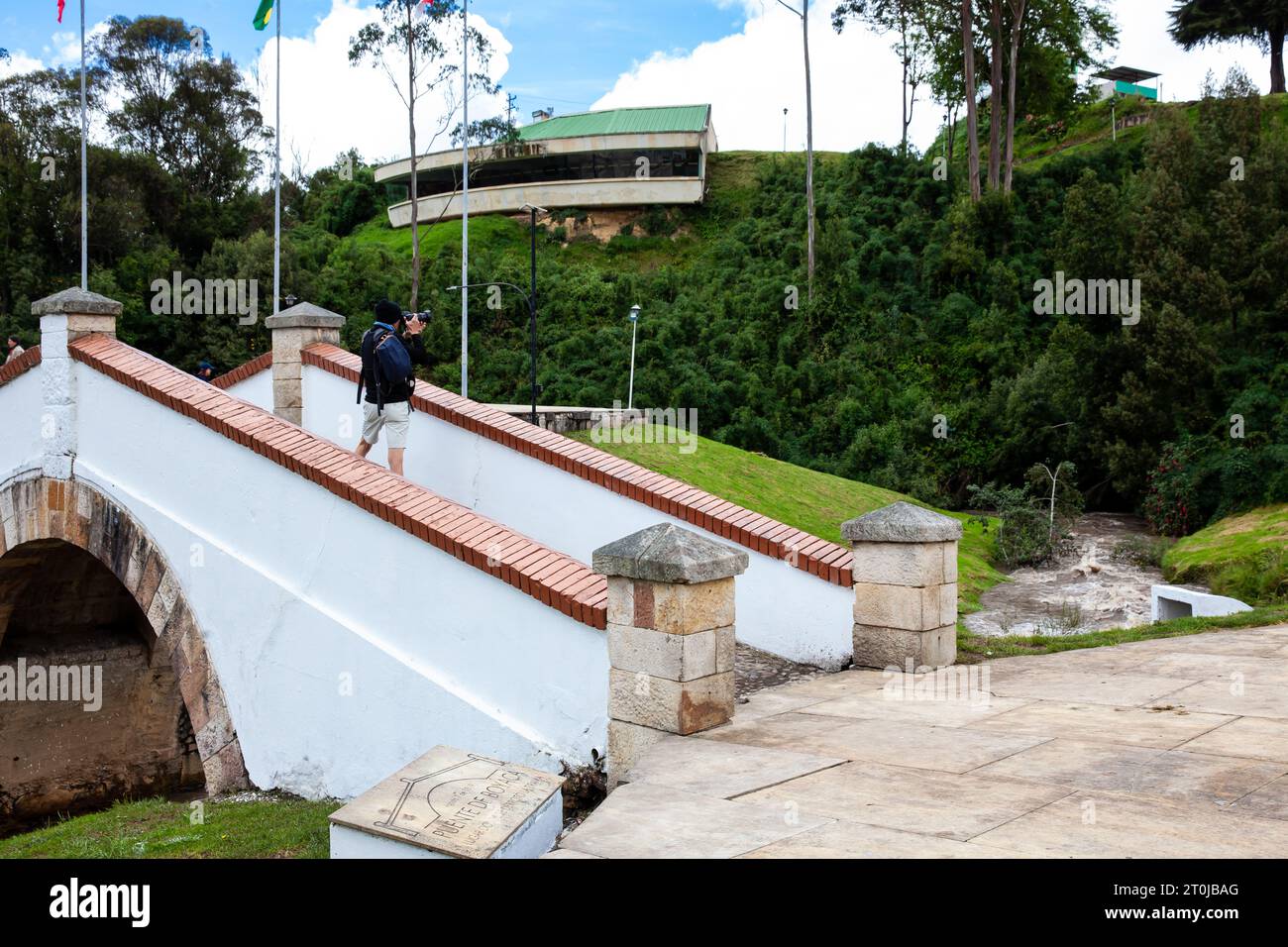 Male tourist taking photos at the famous historic Bridge of Boyaca in ...