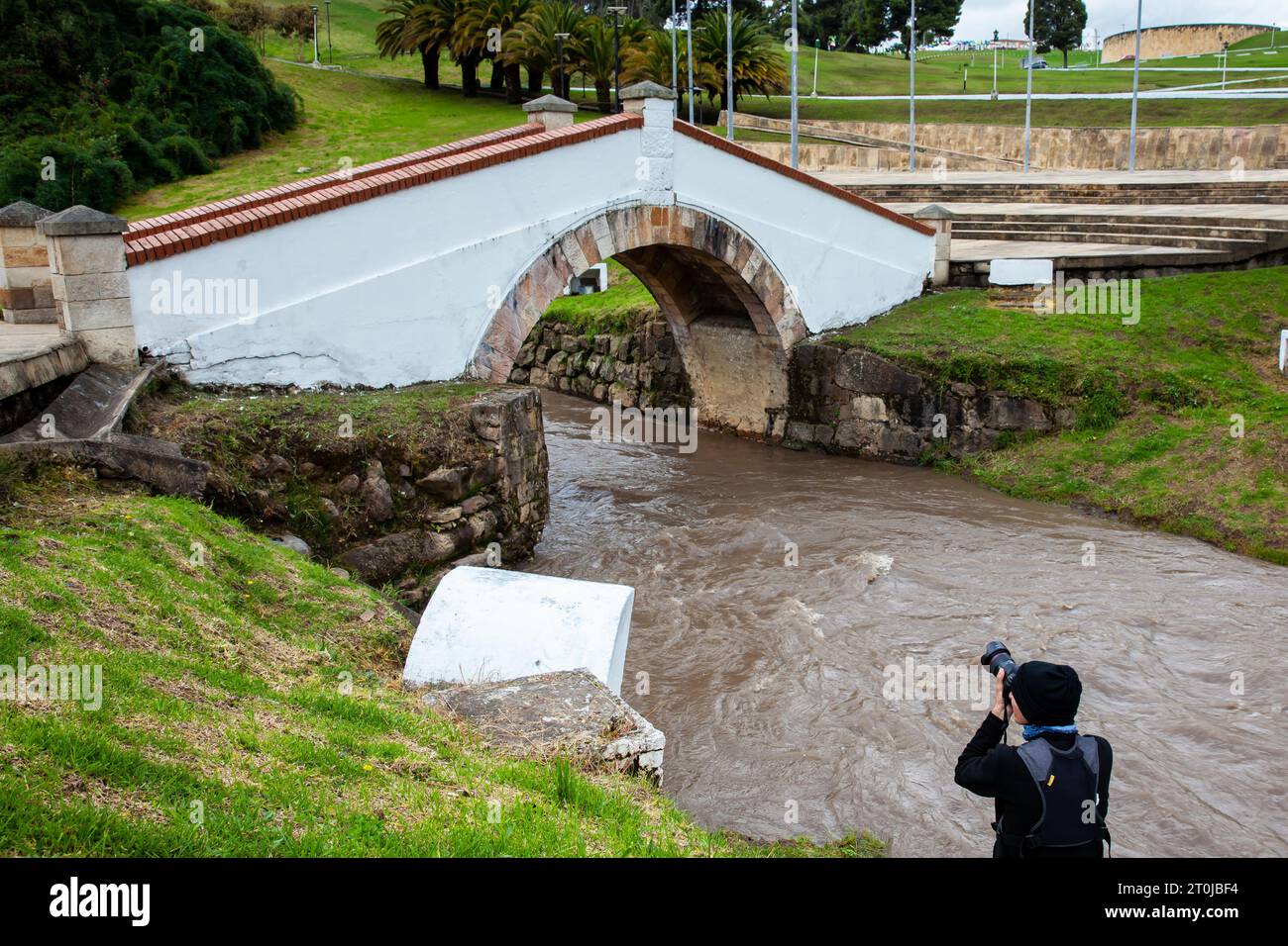 Male tourist taking photos at the famous historic Bridge of Boyaca in ...