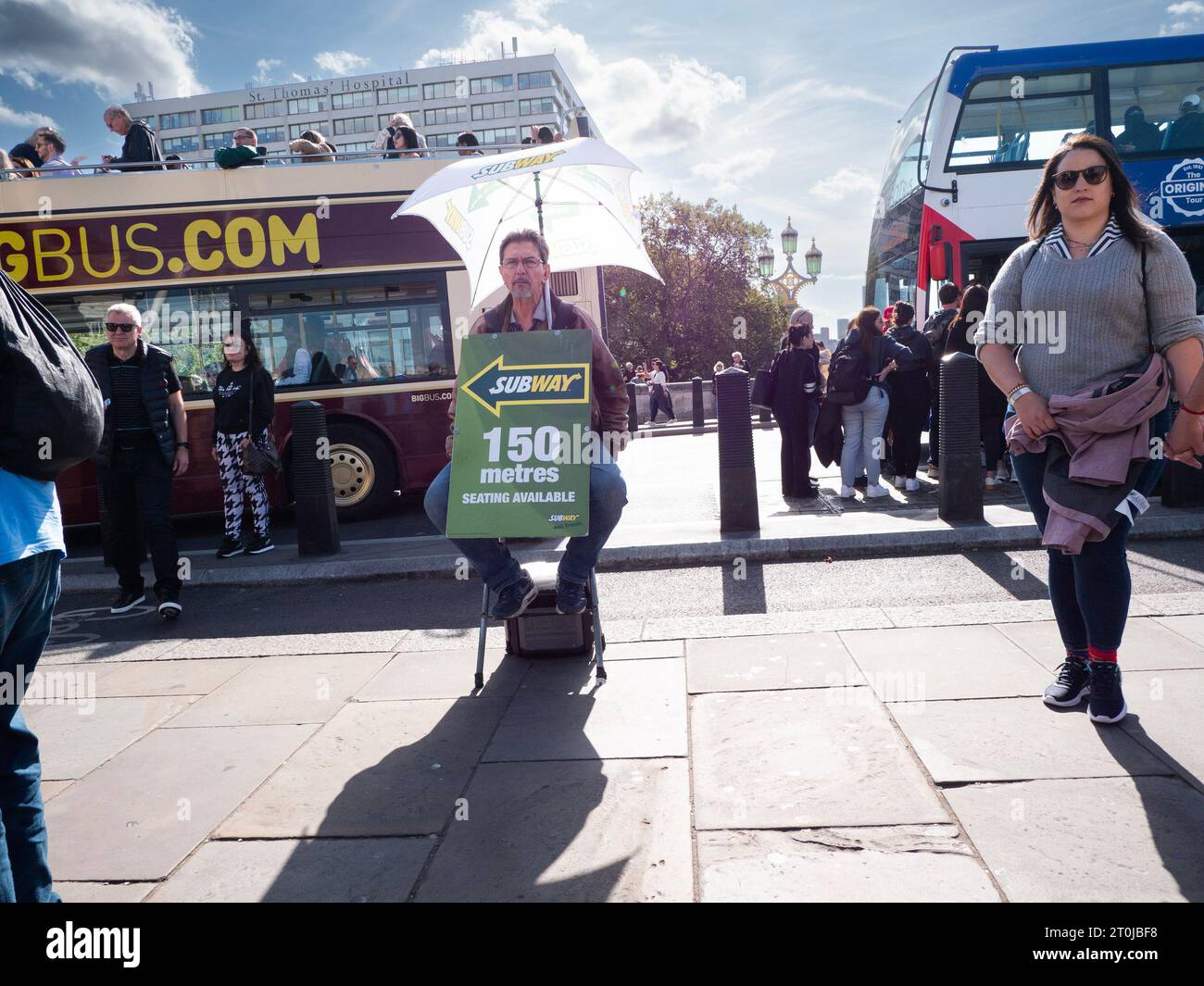 Man holding Sandwich board sign and umbrella on Westminster Bridge ...