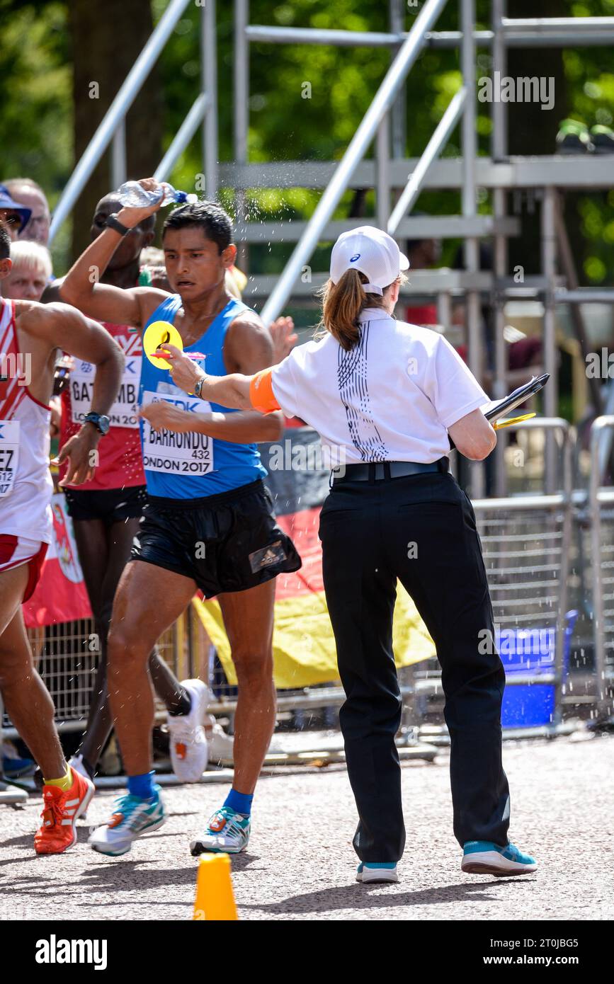 Judge showing a caution paddle to a competing athlete in the IAAF World ...