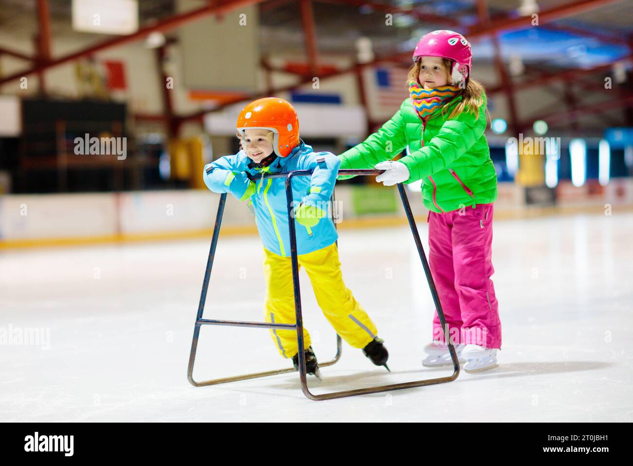Child skating on indoor ice rink. Kids skate. Active family sport ...
