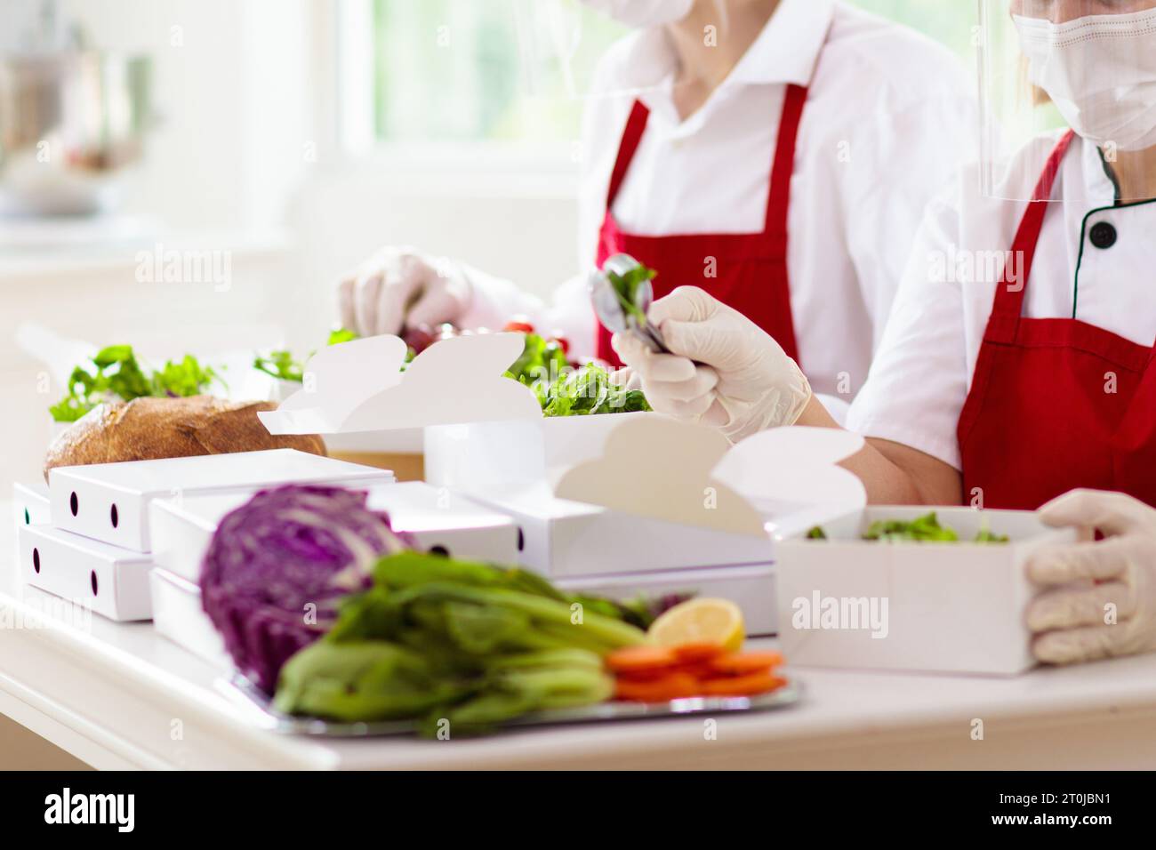 Food takeaway in restaurant. Cafe staff cooking takeout order. Safety ...