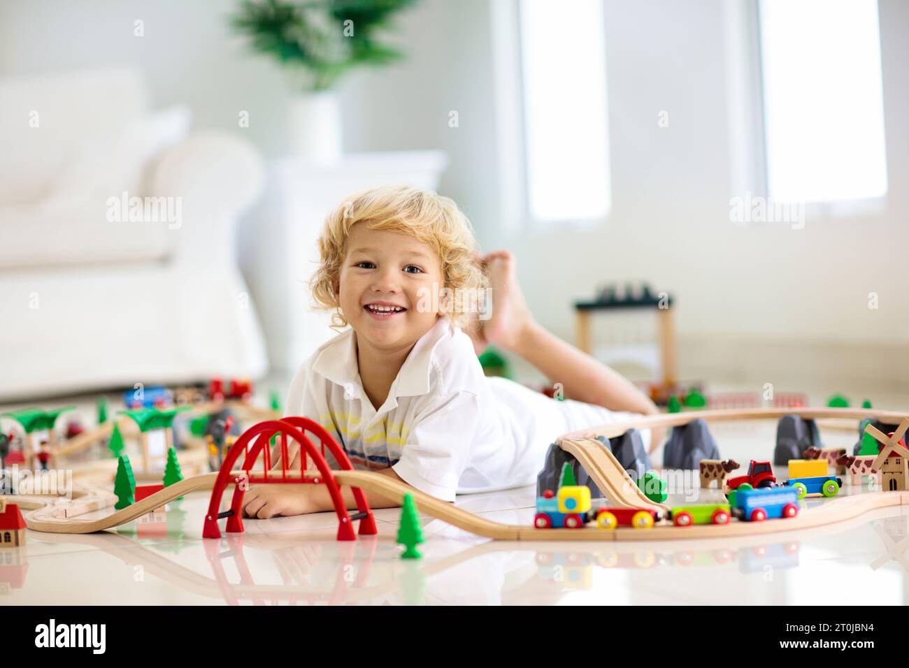 Kids play with wooden railway. Child with toy train. Educational toys ...