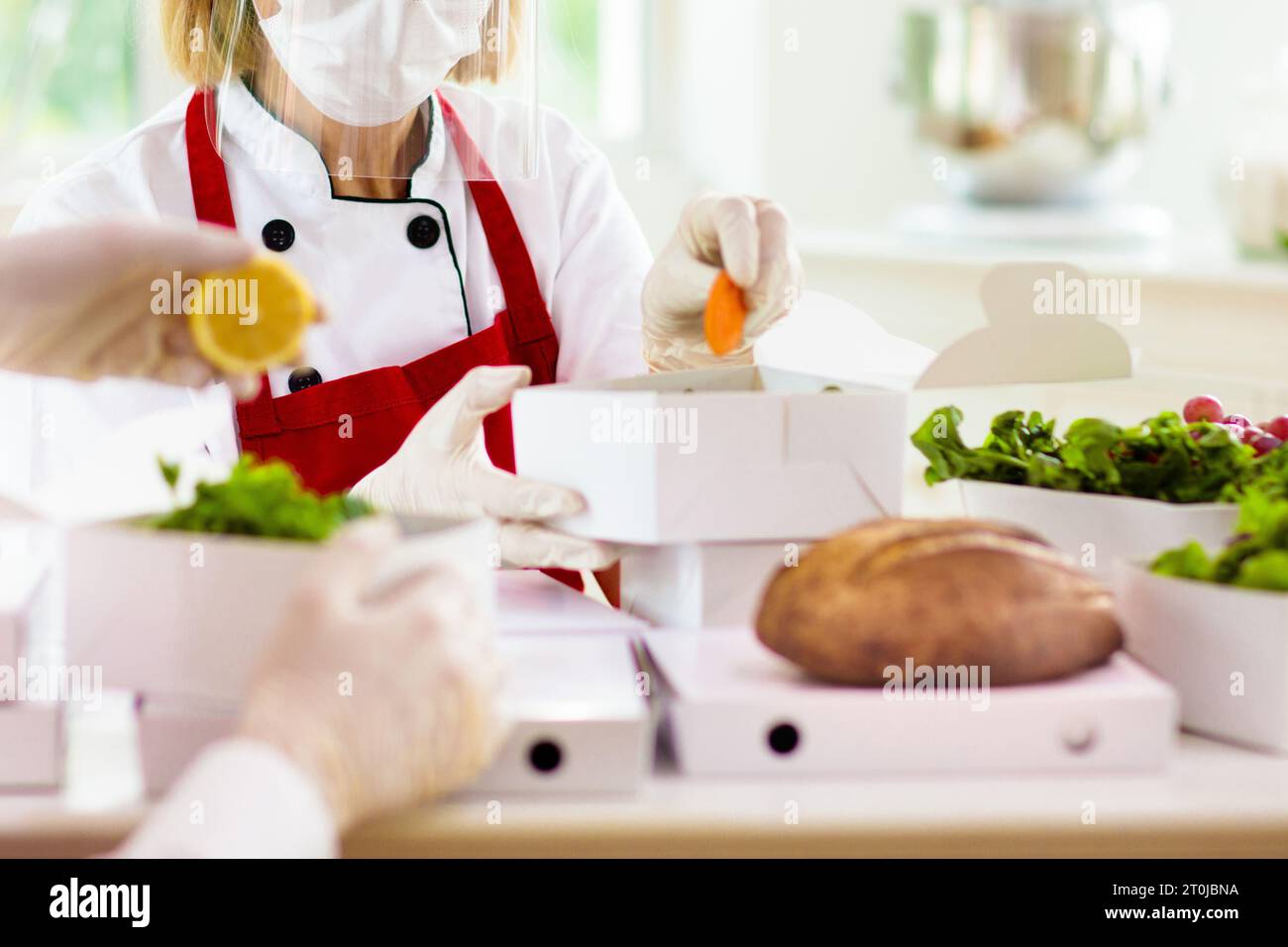 Food takeaway in restaurant. Cafe staff cooking takeout order. Safety ...