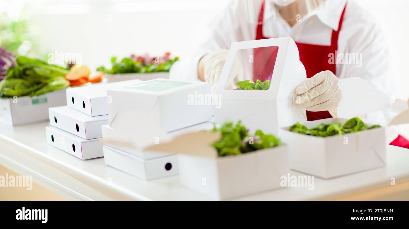Food takeaway in restaurant. Cafe staff cooking takeout order. Safety ...
