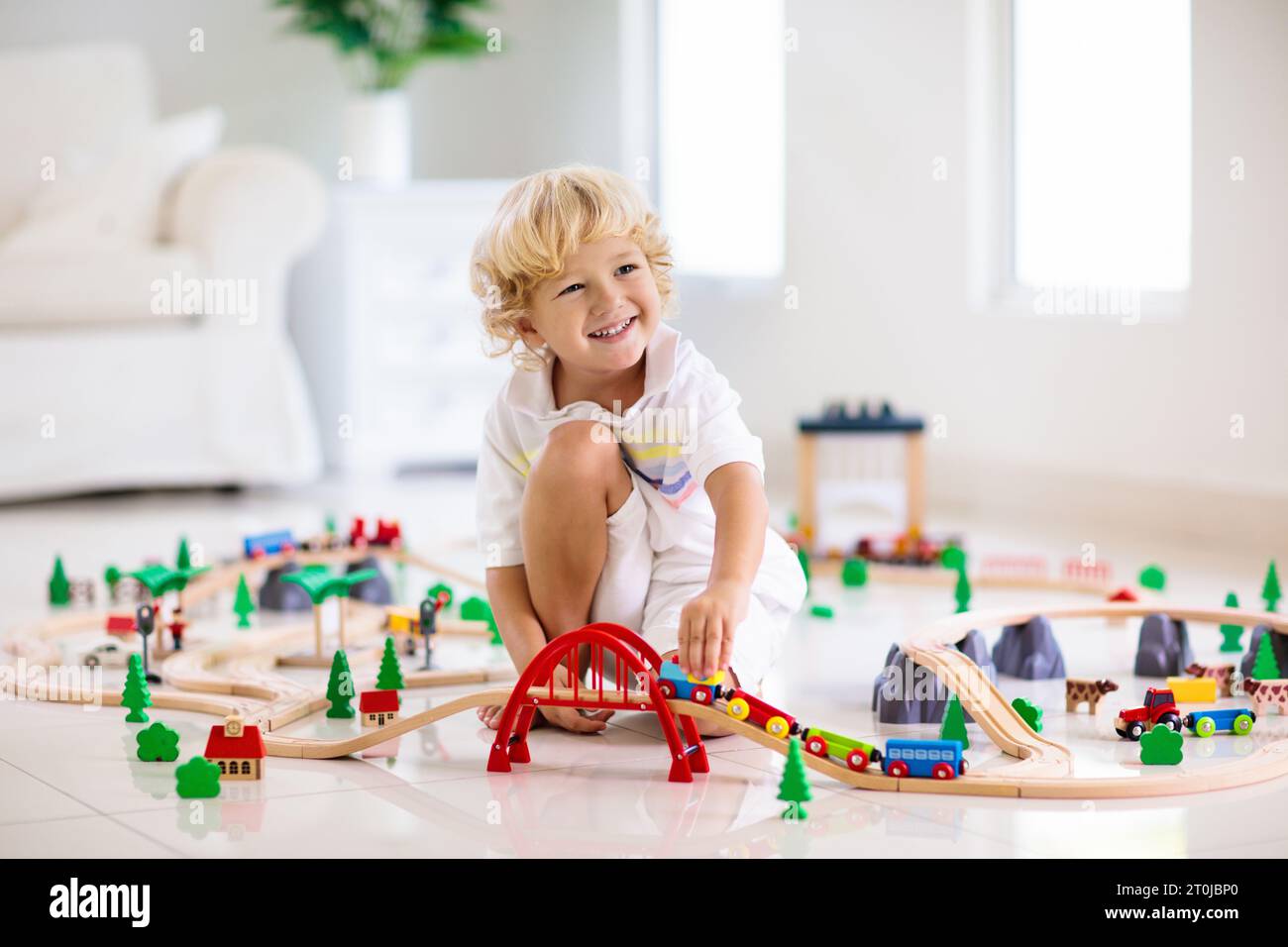 Kids play with wooden railway. Child with toy train. Educational toys ...