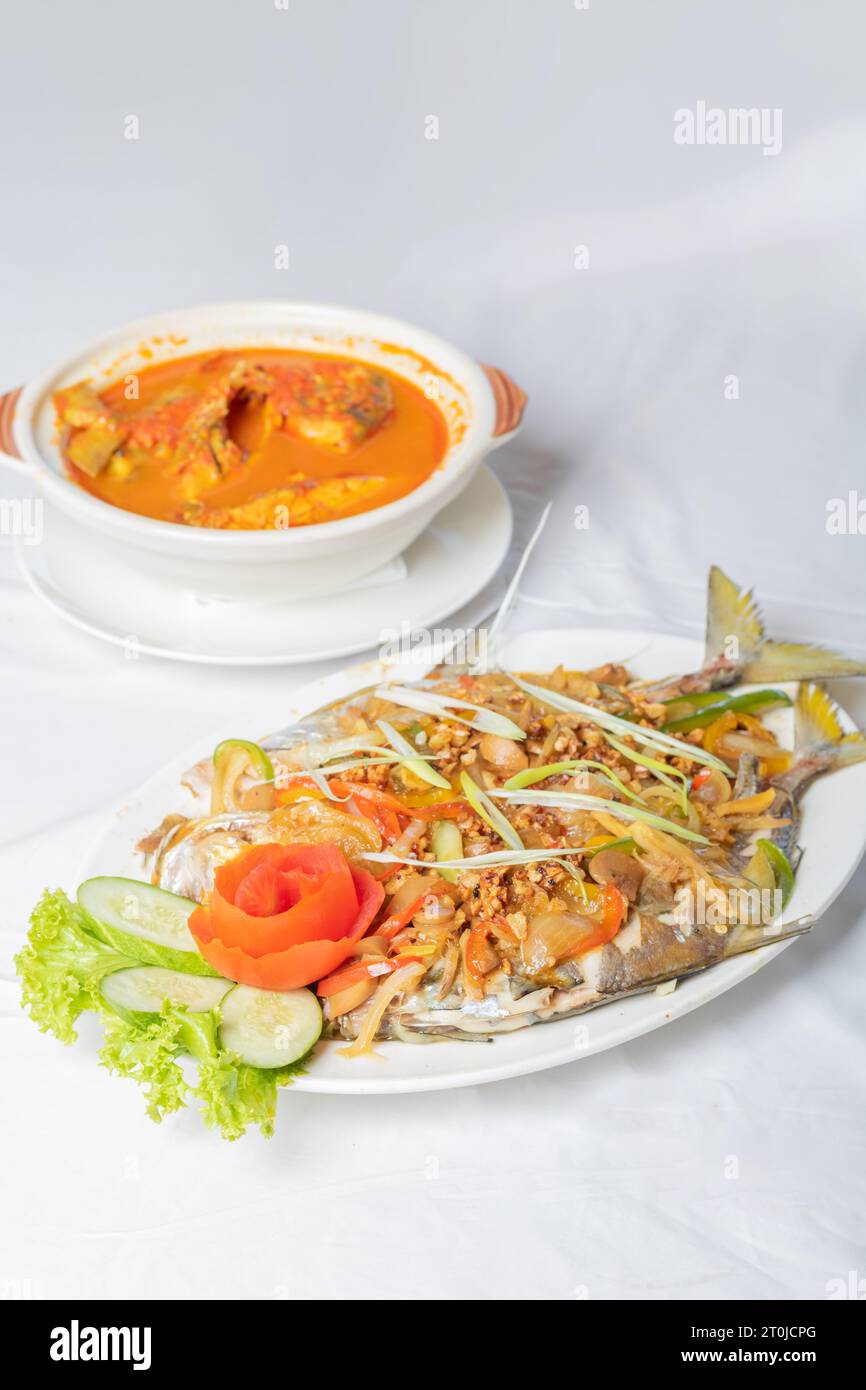steamed pompano or kuwe fish with sweet and spicy sauce and beautiful ...