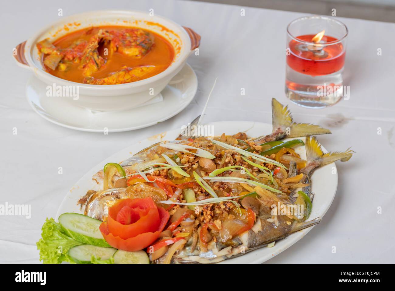 steamed pompano or kuwe fish with sweet and spicy sauce and beautiful ...
