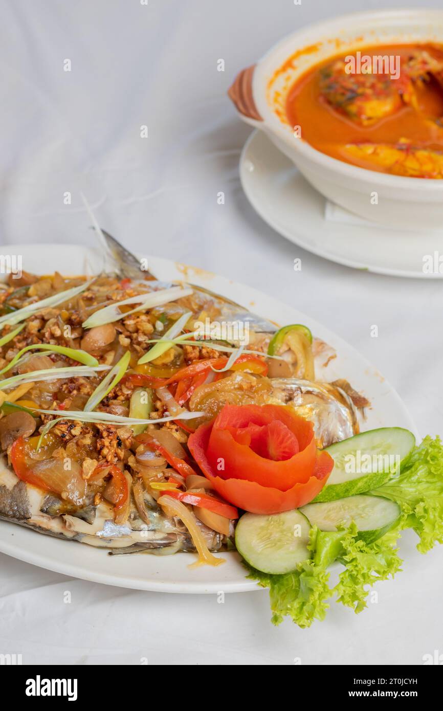 steamed pompano or kuwe fish with sweet and spicy sauce and beautiful ...
