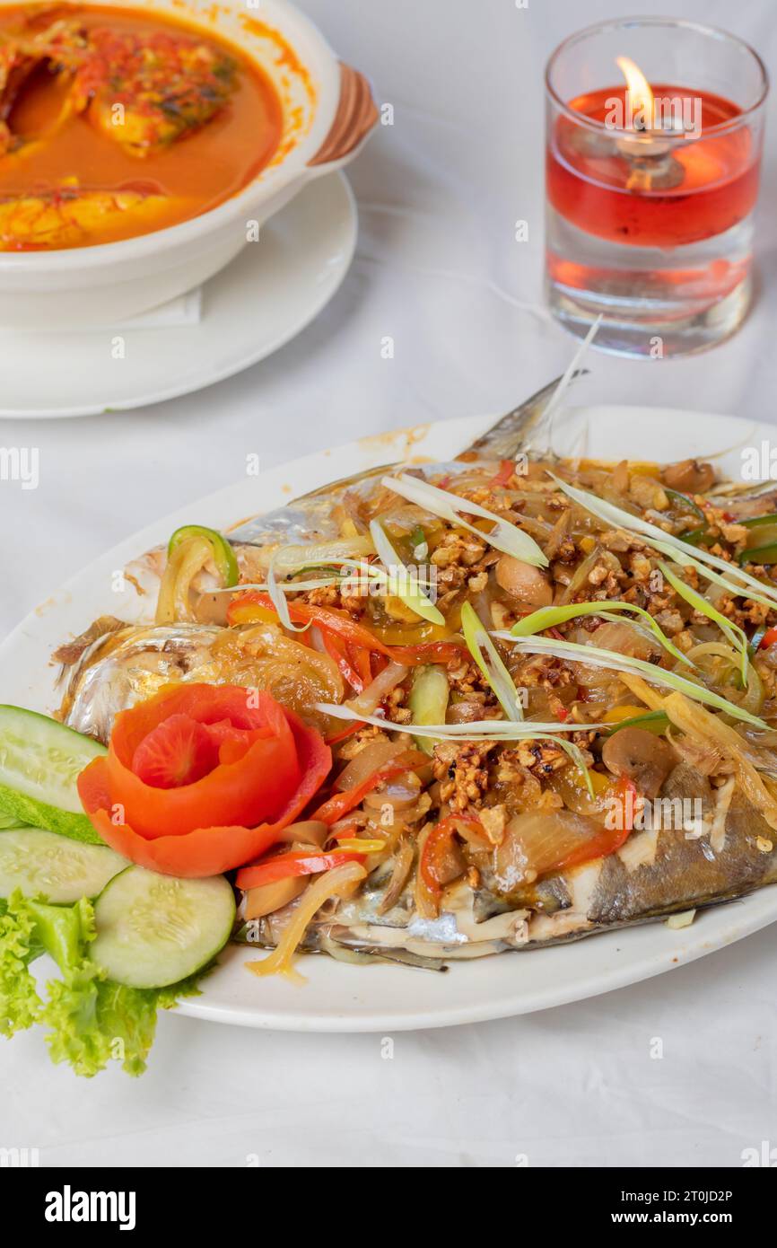steamed pompano or kuwe fish with sweet and spicy sauce and beautiful ...