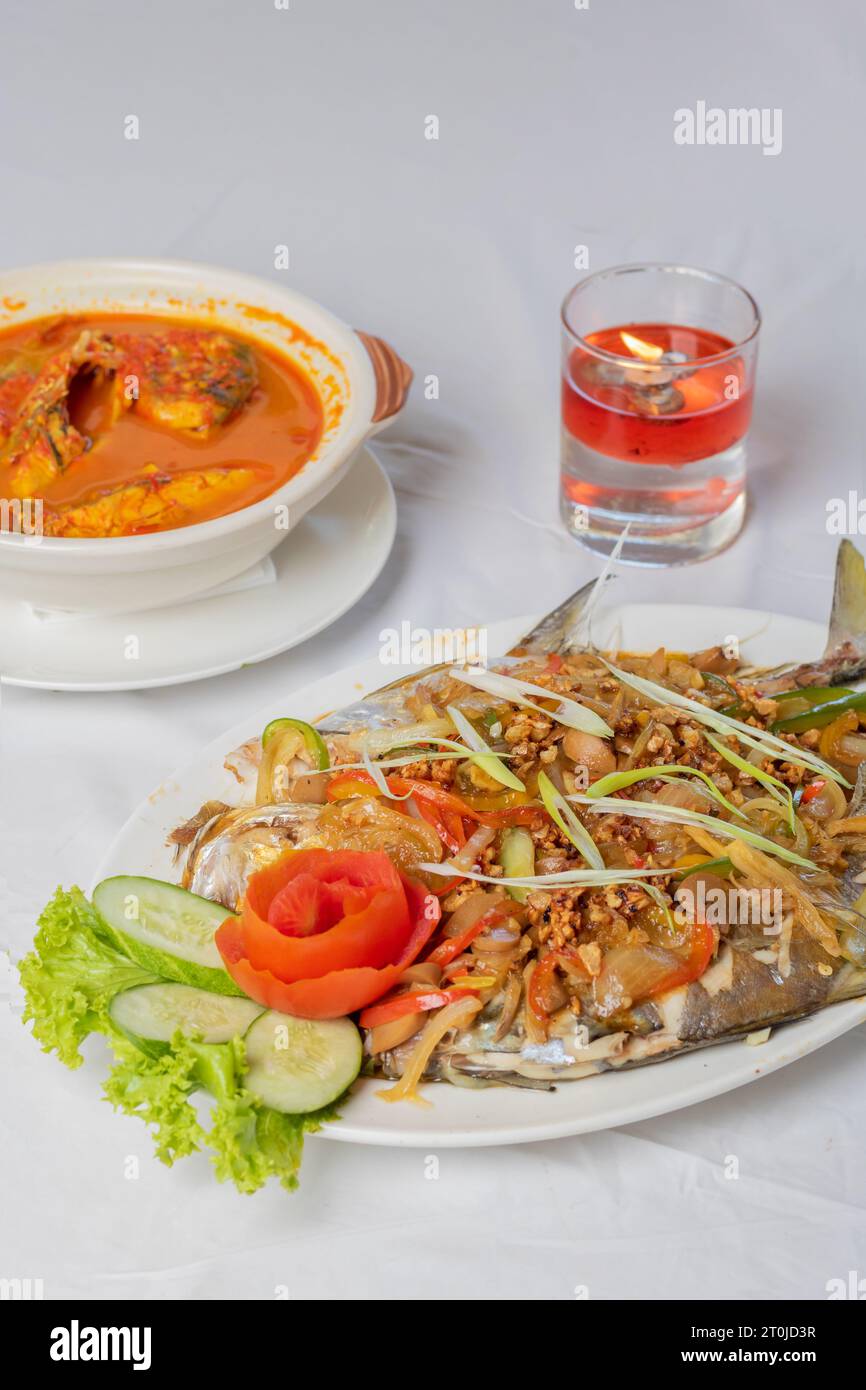 steamed pompano or kuwe fish with sweet and spicy sauce and beautiful ...