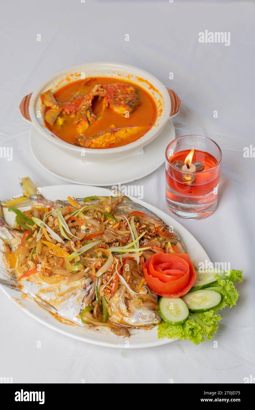steamed pompano or kuwe fish with sweet and spicy sauce and beautiful ...