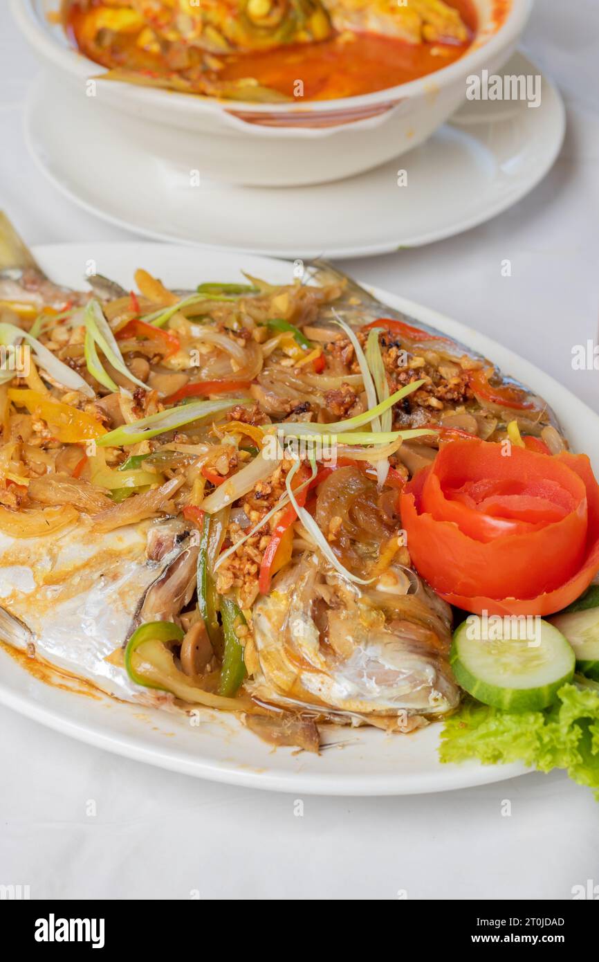 steamed pompano or kuwe fish with sweet and spicy sauce and beautiful ...