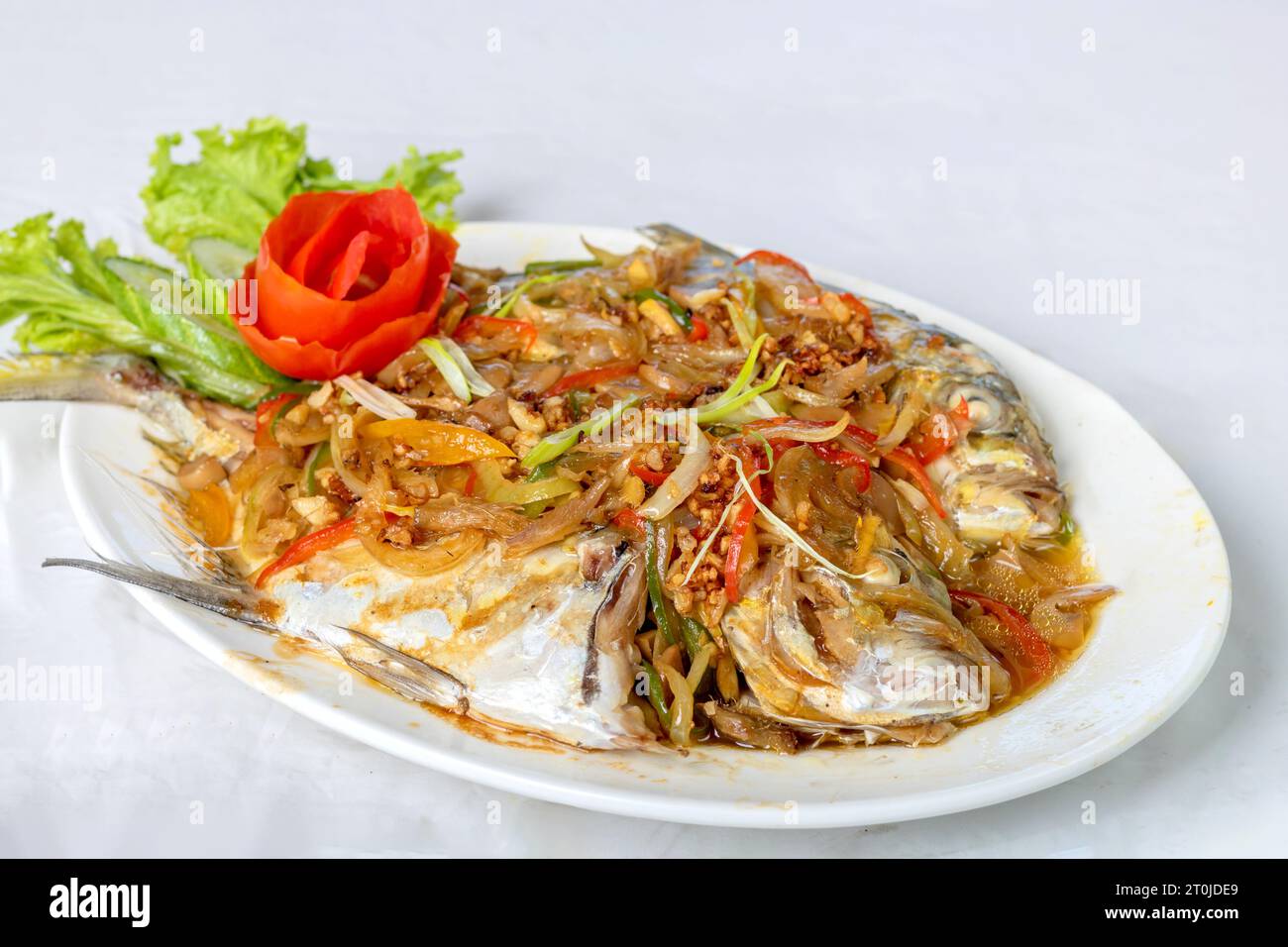 steamed pompano or kuwe fish with sweet and spicy sauce and beautiful ...