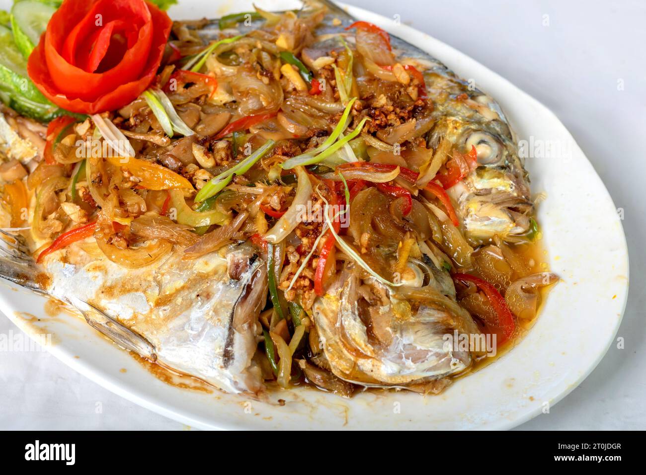 steamed pompano or kuwe fish with sweet and spicy sauce and beautiful ...