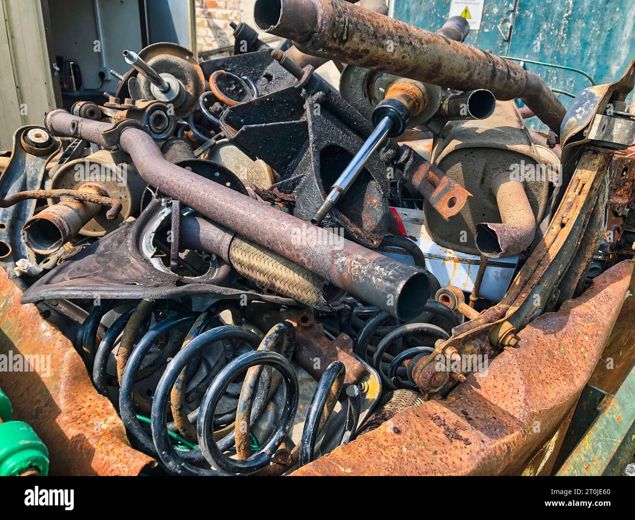 Redundant car parts waiting disposal in a skip Stock Photo - Alamy