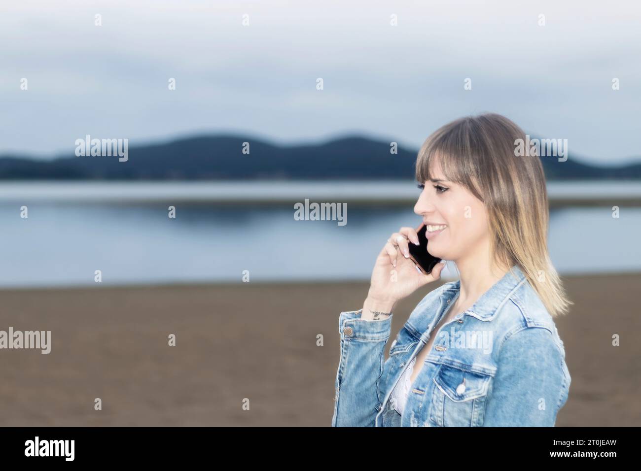 Denim-Clad Figure Against a Seascape: Moody Coastal Scene Stock Photo ...