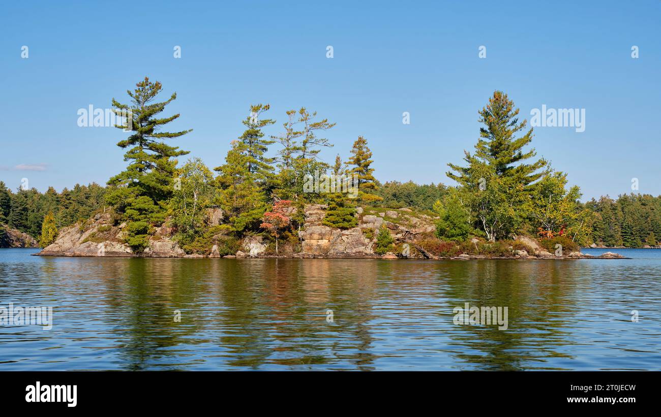 A small island on Skeleton Lake in the Muskokas is covered with trees ...